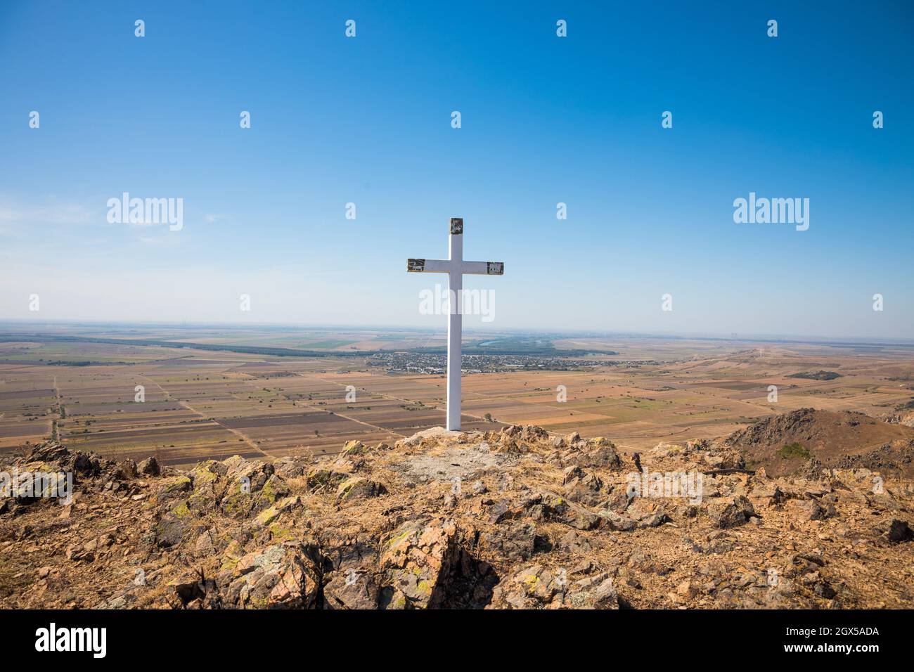 Cross on top of a peak in Macin Mountains, Tulcea, Romania Stock Photo ...