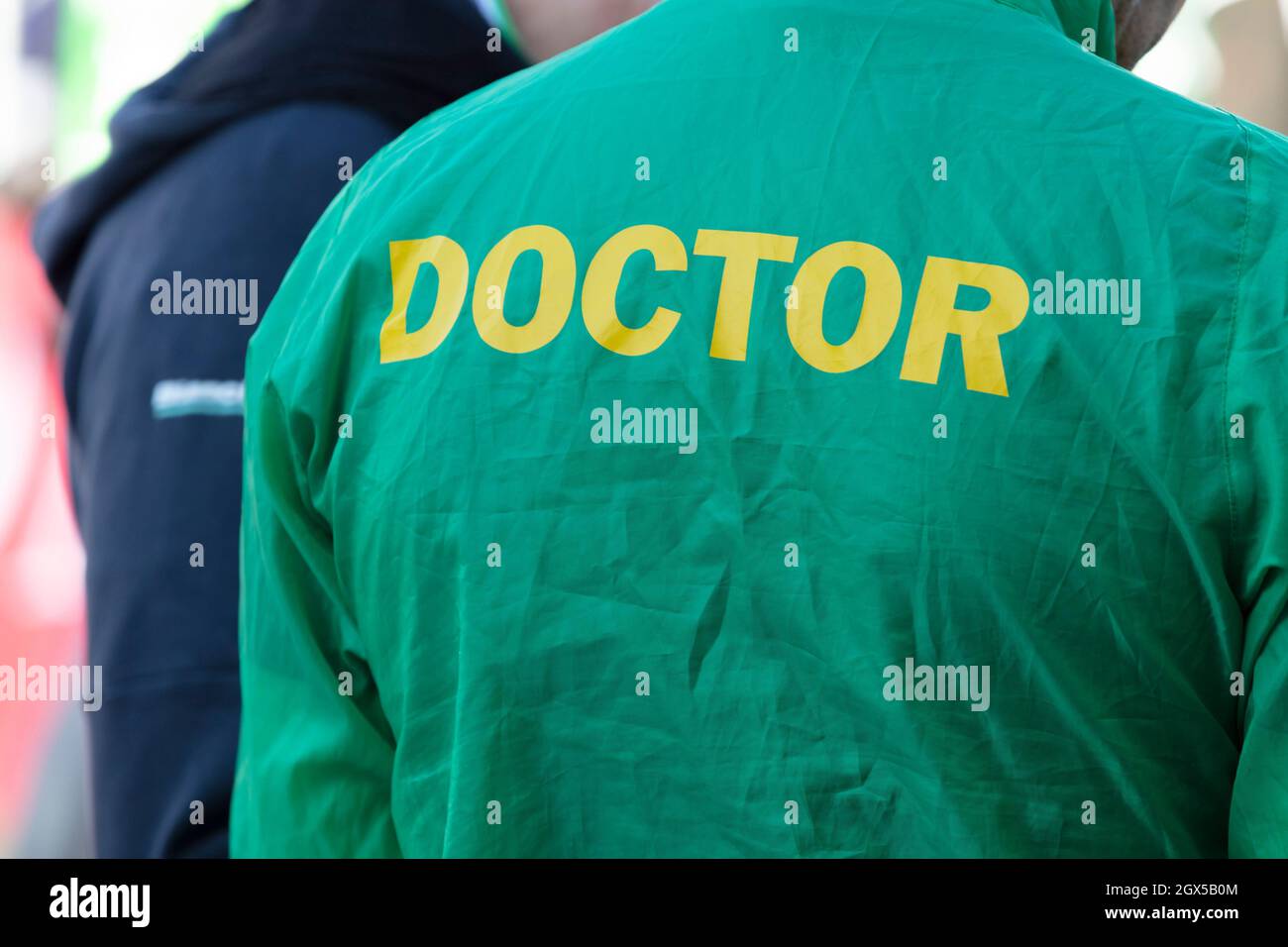 A security guard officer at a public event with tour security on a ...