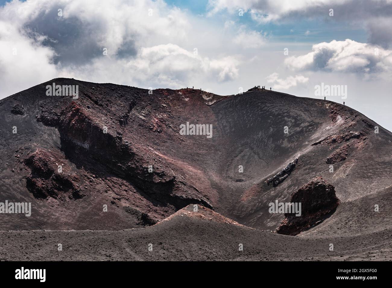 Hiking around the rim of a volcanic crater high on the slopes of Mount ...