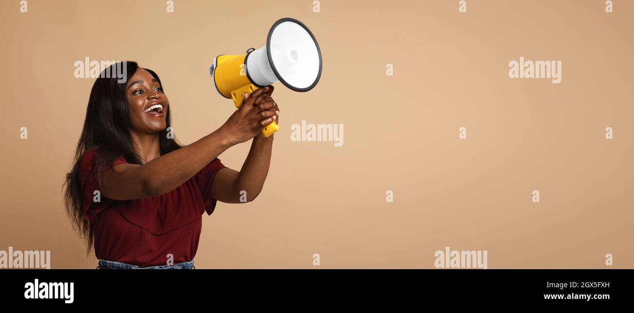 Emotional black woman with megaphone saying something loud Stock Photo ...