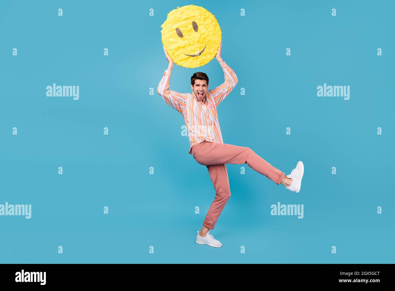 Full size photo of young excited guy happy positive hold big yellow ...