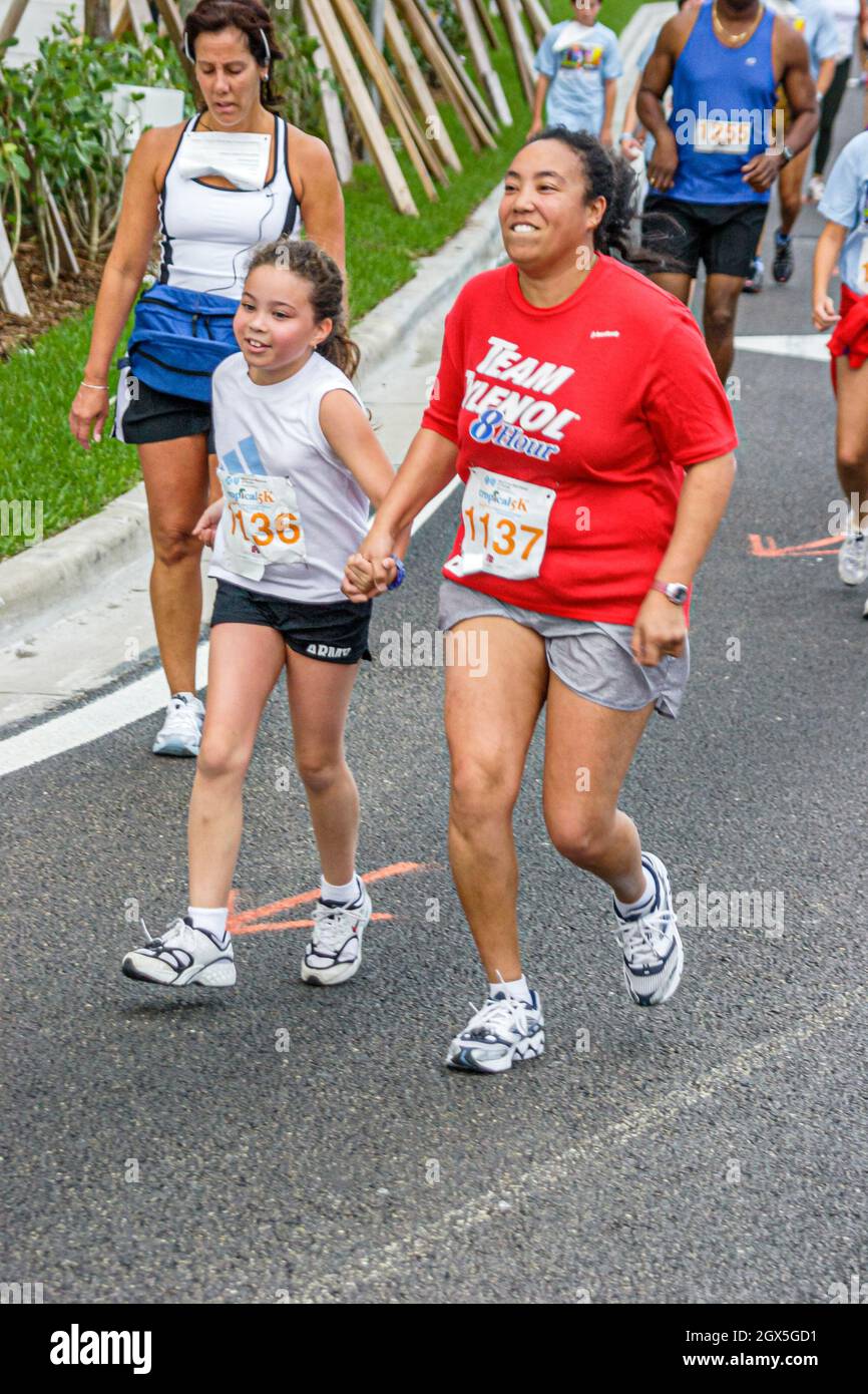 Hispanic woman female daughter girl family parent mother hold hands hi ...