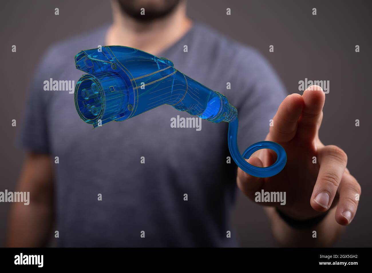 Person presenting a virtual 3D rendered projection of an electric plug ...