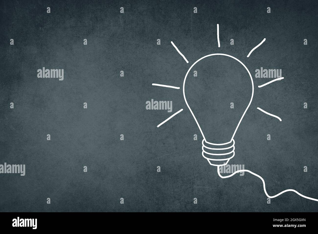 A white bulb on a dark textured background, symbol for idea, creativity ...