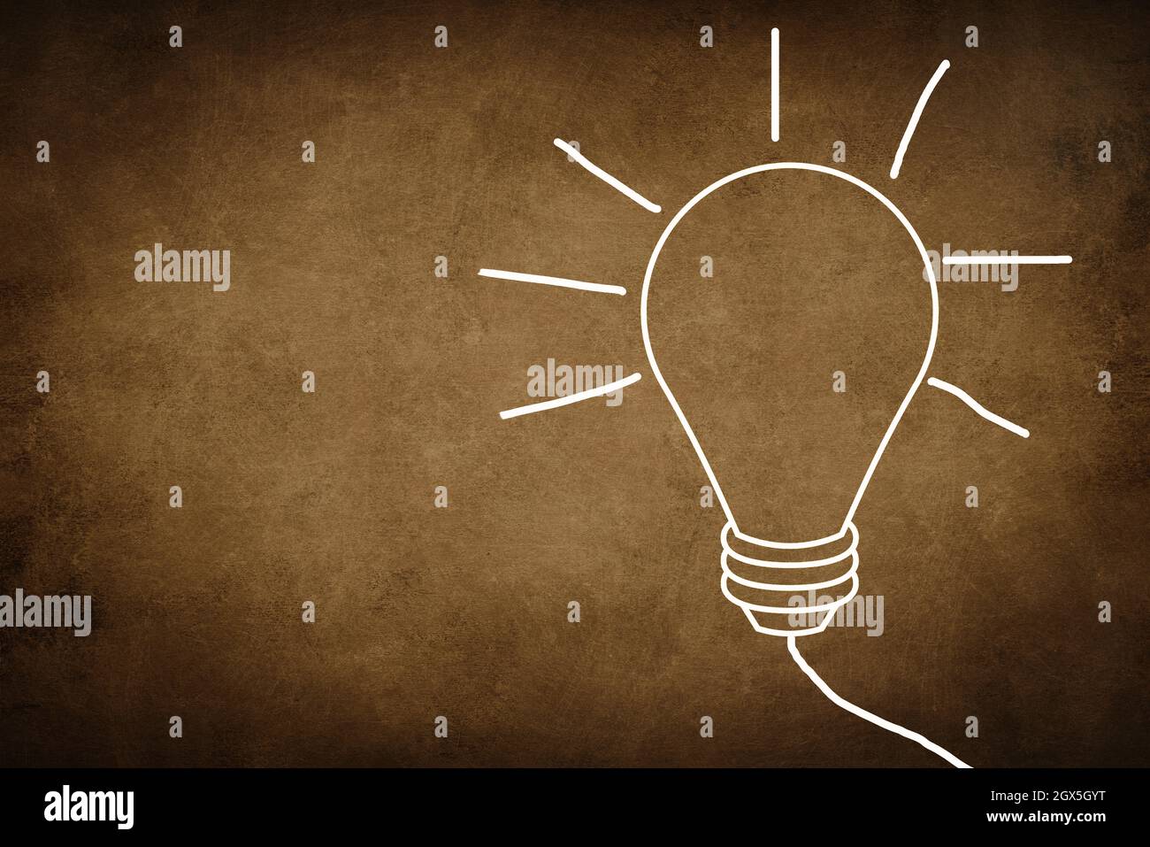 A white bulb on a dark brown textured background, symbol for idea ...
