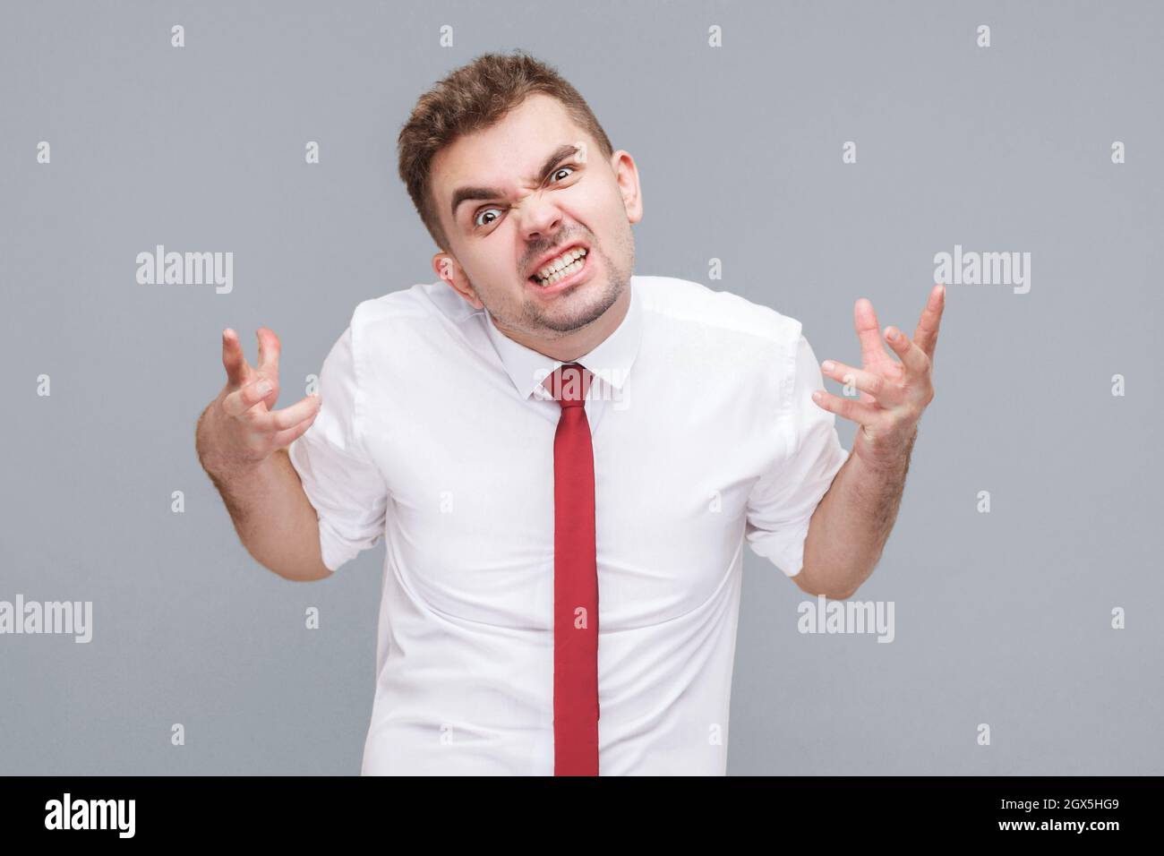 what do you want. Portrait of young crazy angry man in white shirt and ...