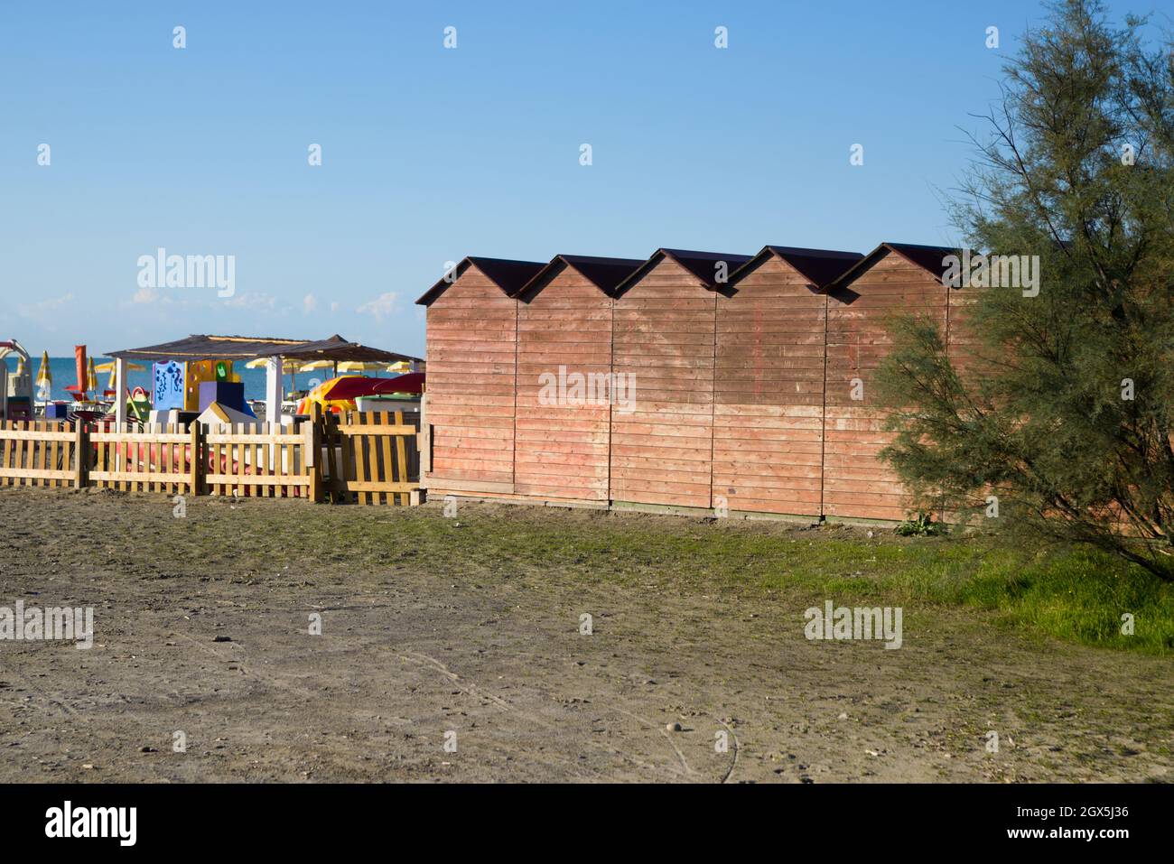 Abandoned white and wooden bathing structures on the sandy beach of ...