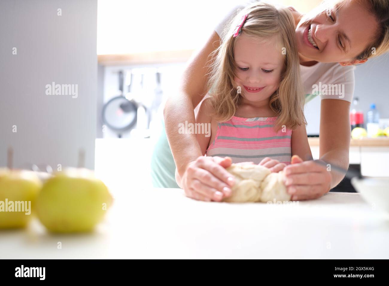 Mother and daughter kneading dough to make buns at home Stock Photo - Alamy