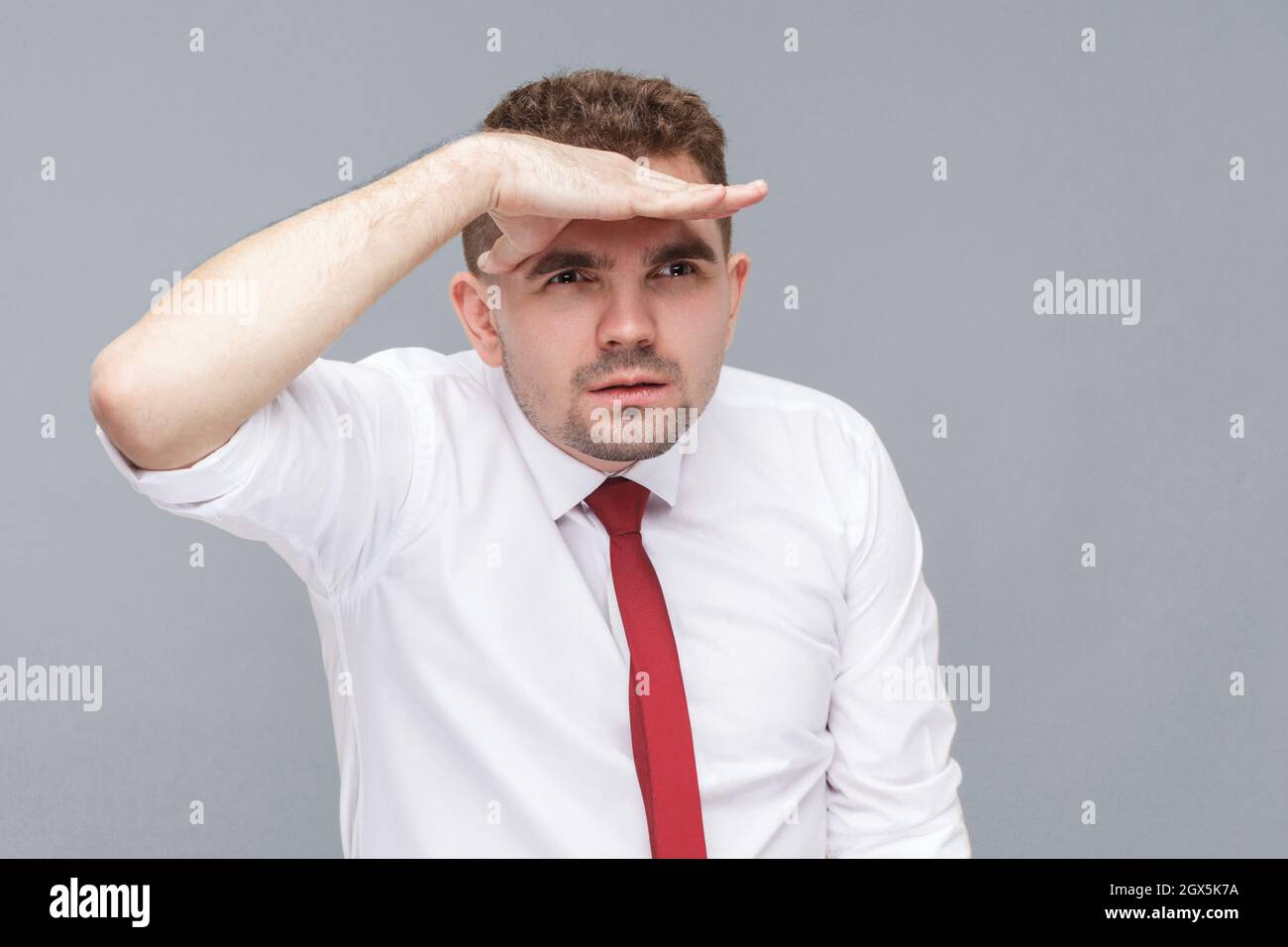 Portrait of young handsome attentive man in white shirt and tie ...