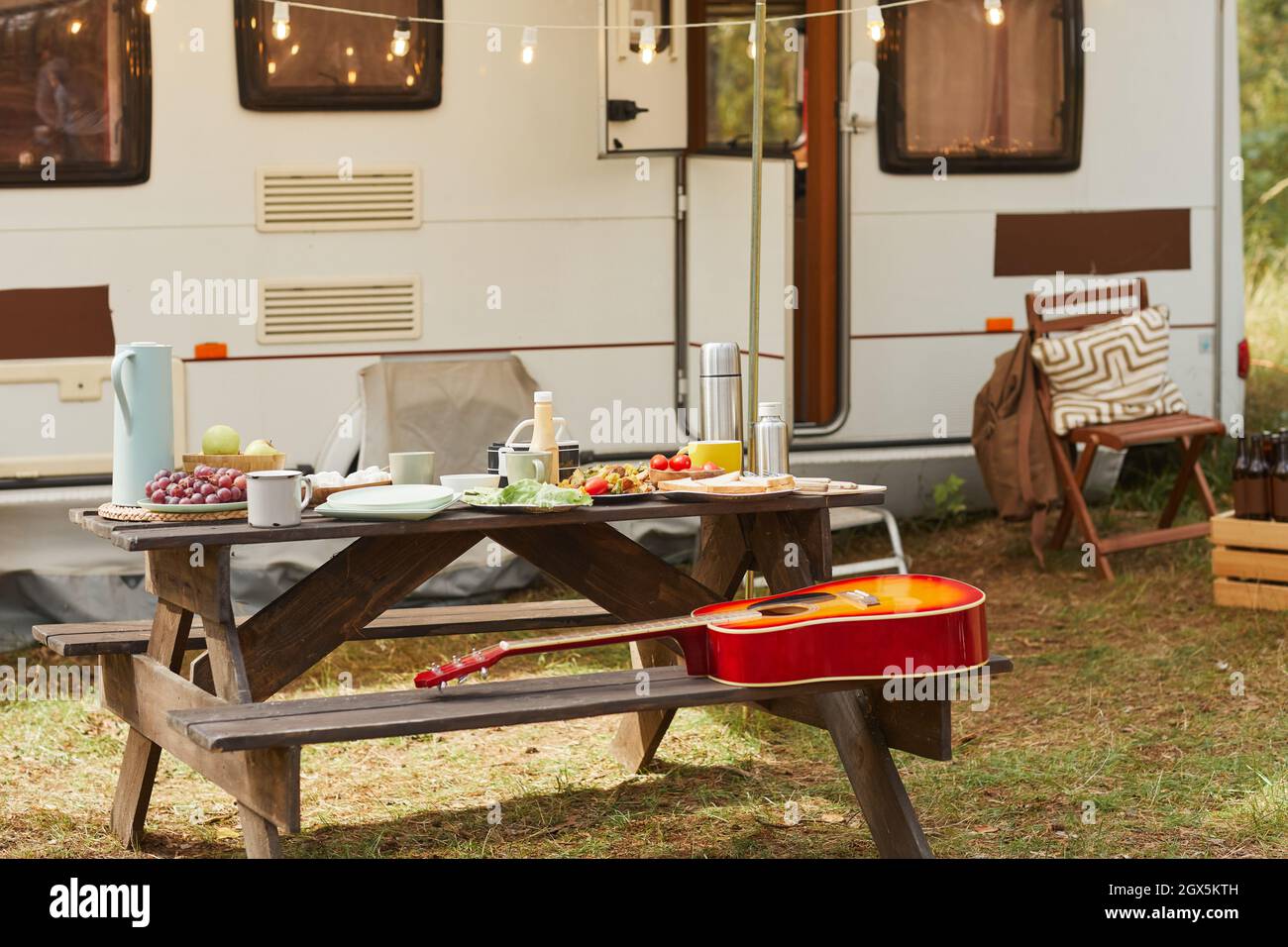 Background image of cozy outdoor camping area with picnic table and ...