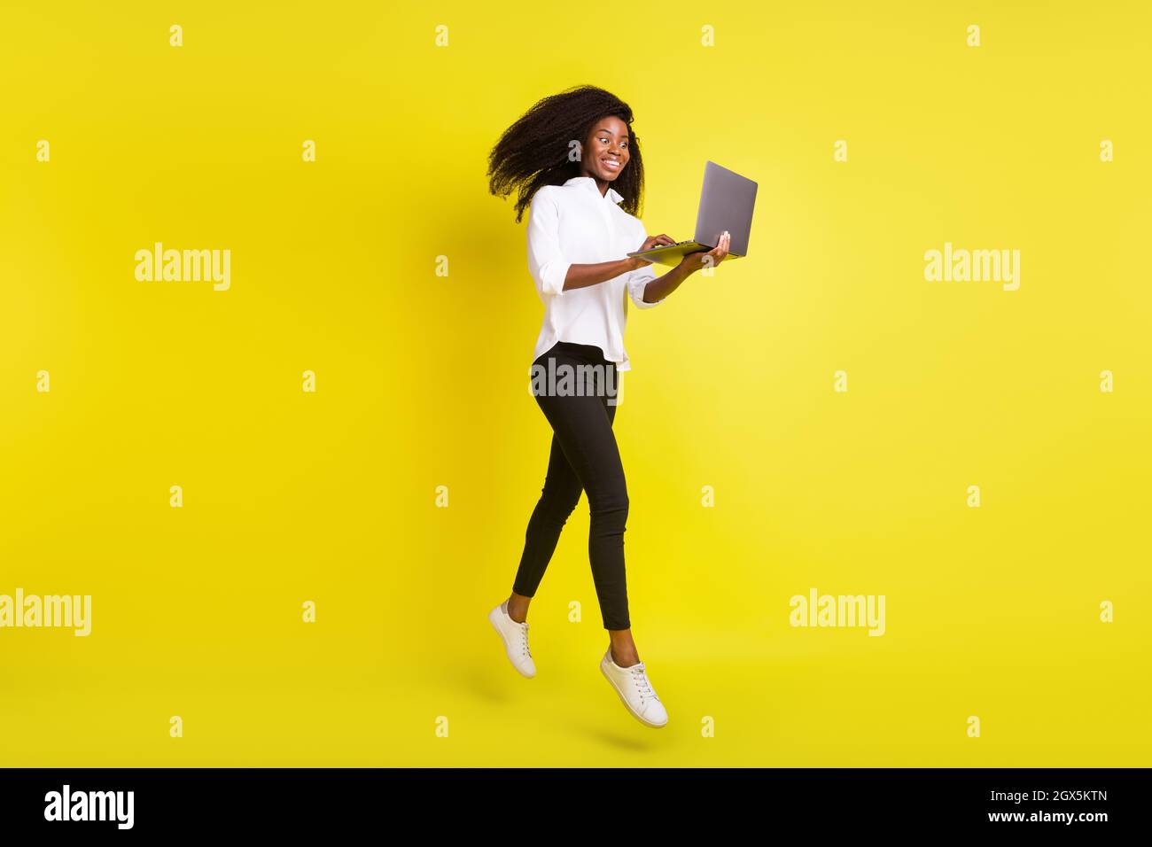 Full length body size photo crazy woman jumping up typing message with ...