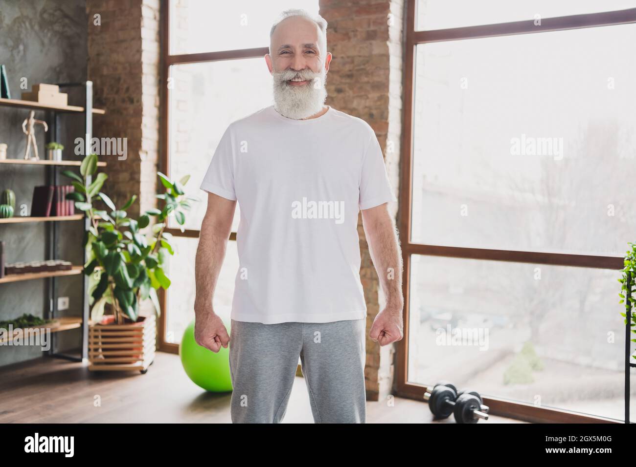 Photo of handsome happy positive smiling cheerful sportive grandfather ...