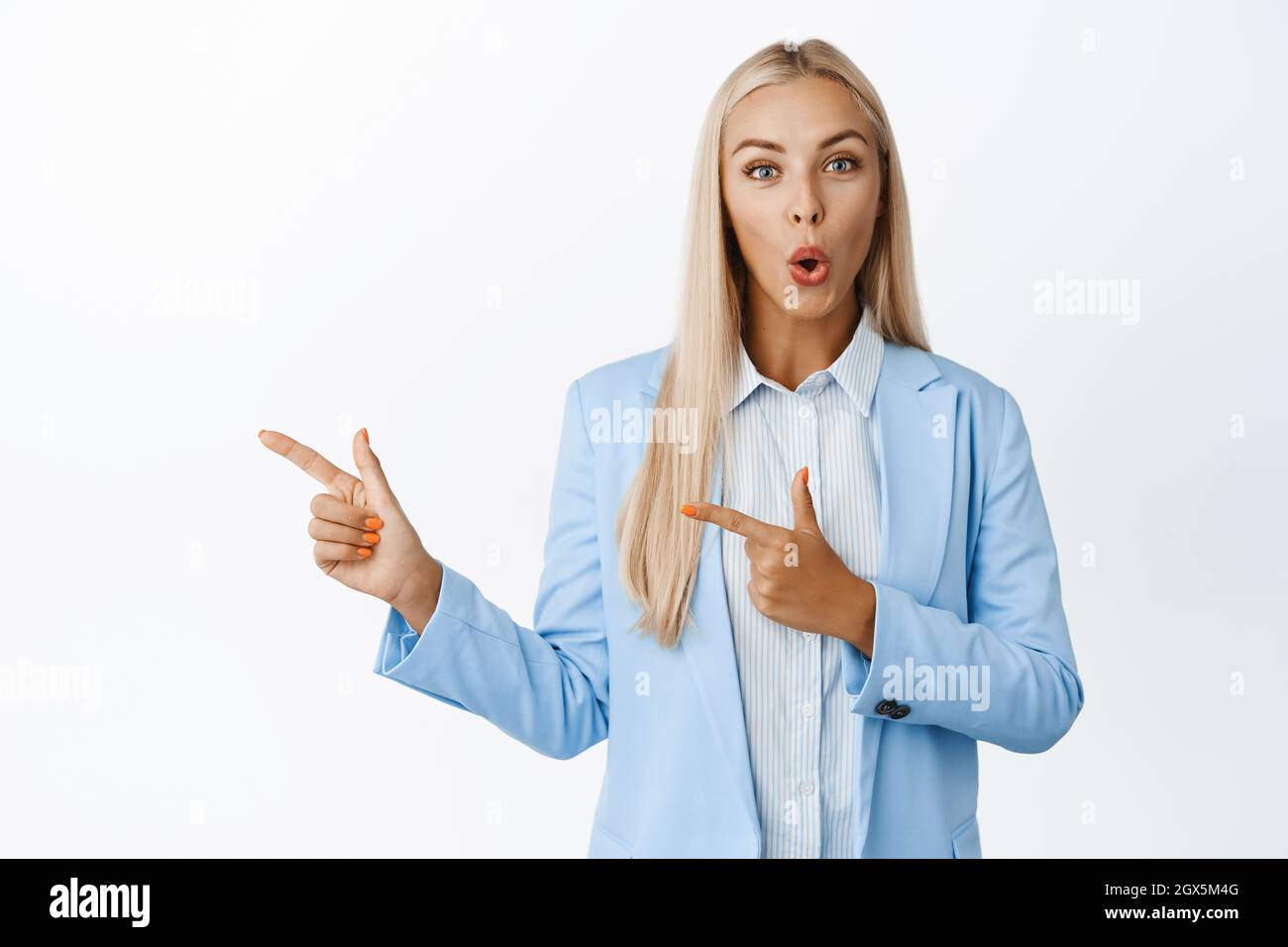 Image of enthusiastic businesswoman pointing fingers left, say wow ...