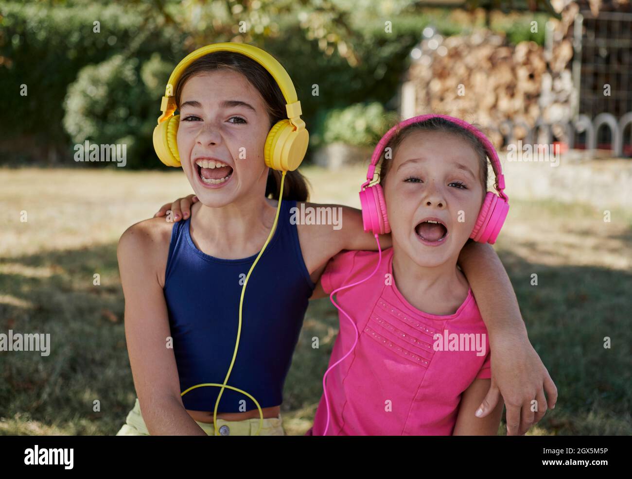 Front view of two girls smiling and laughing in front of camera with ...