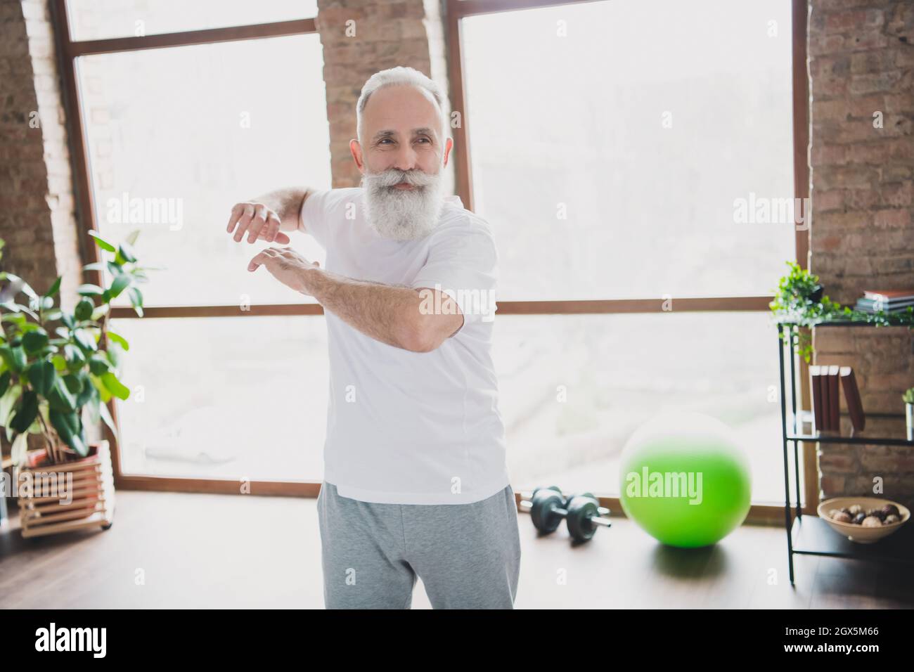 Photo of handsome positive good mood sportive grandfather training ...
