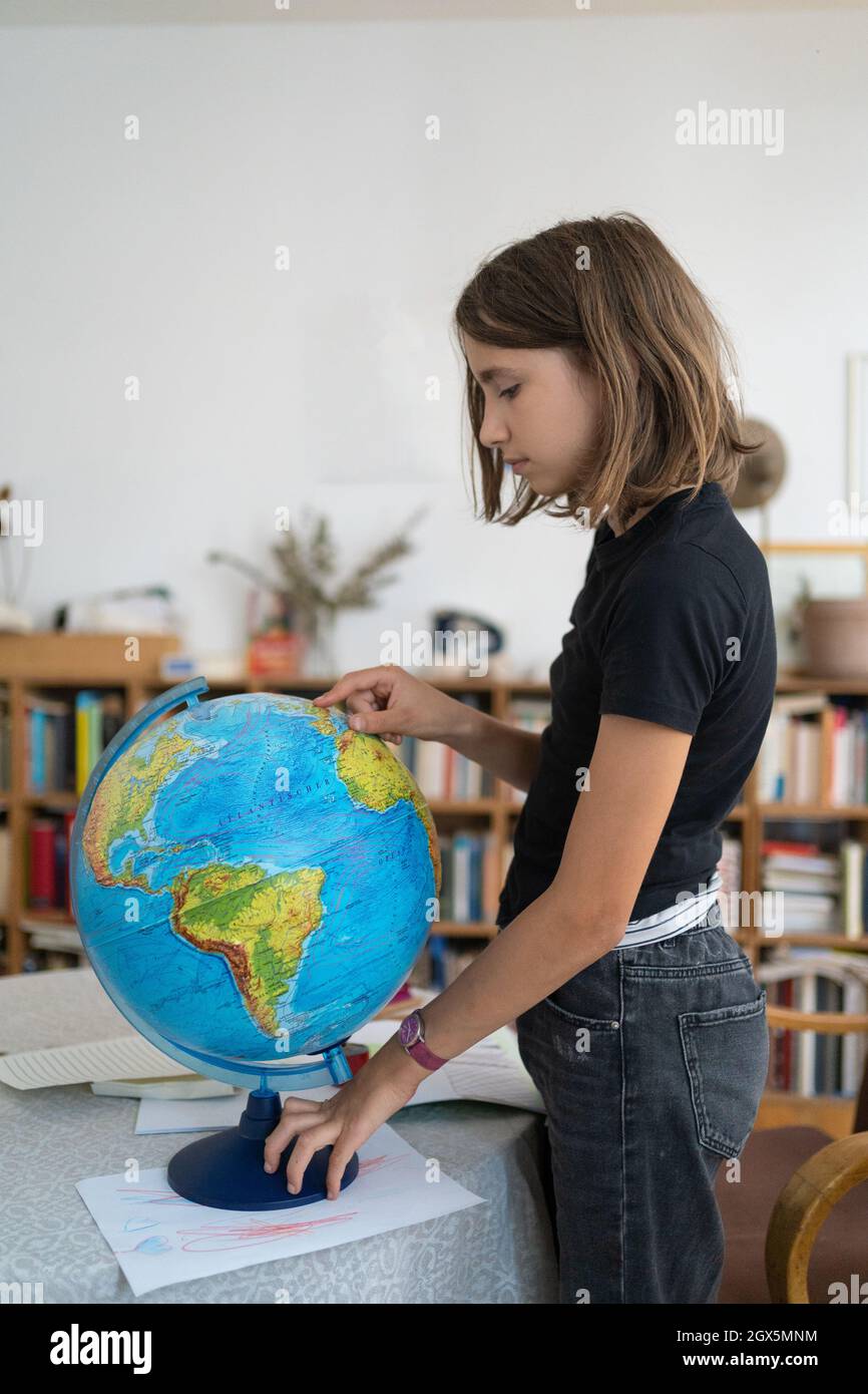 Person looking at world globe hi-res stock photography and images - Alamy