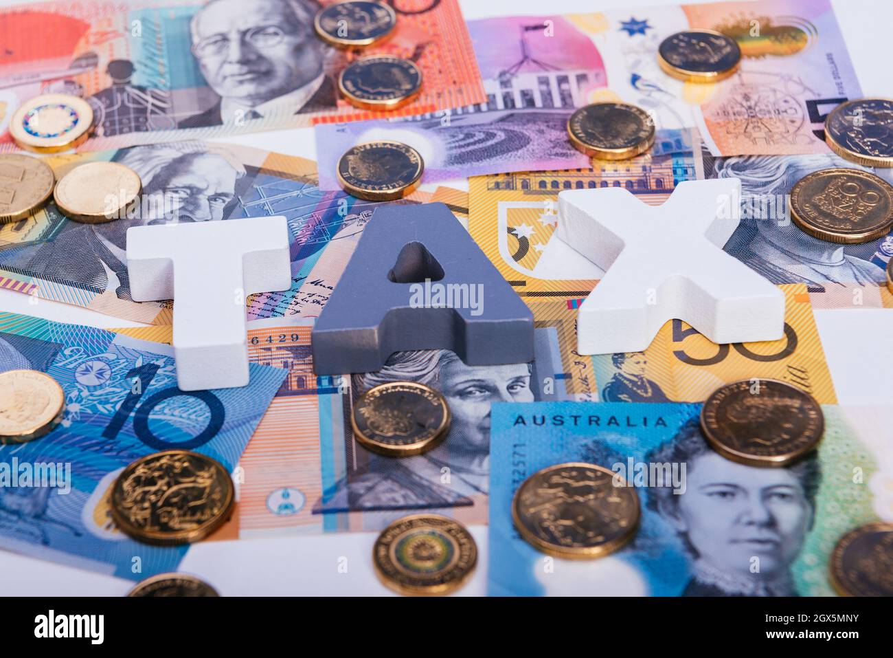 Word TAX on Australian currency background Stock Photo - Alamy