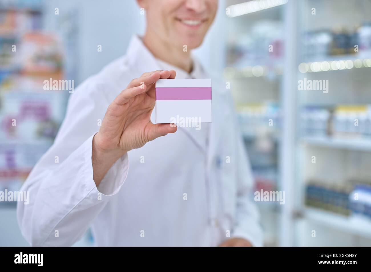 Male hand showing packaging of medicinal product Stock Photo - Alamy