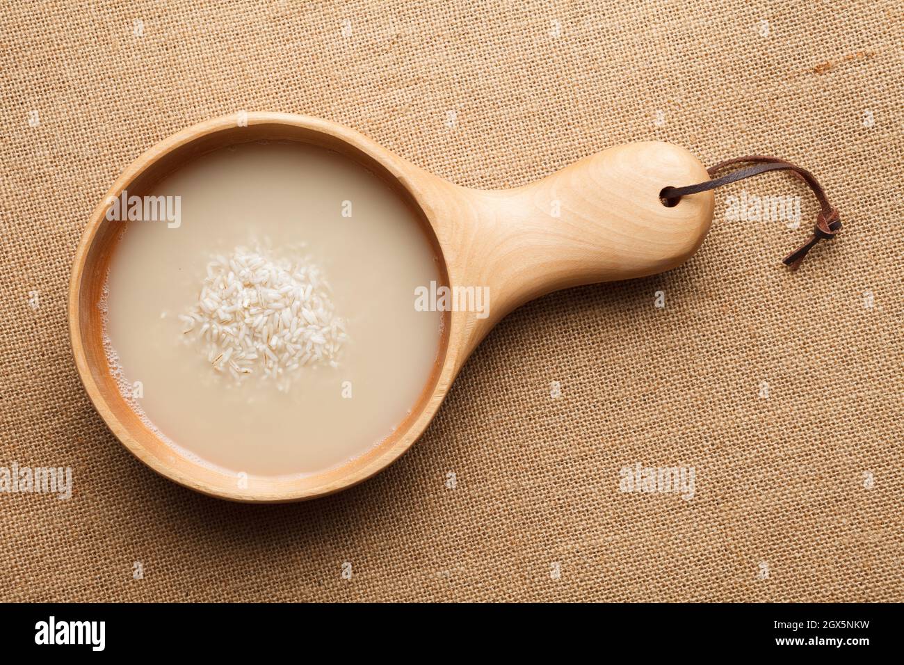 Wash rice in wooden bowl Stock Photo - Alamy
