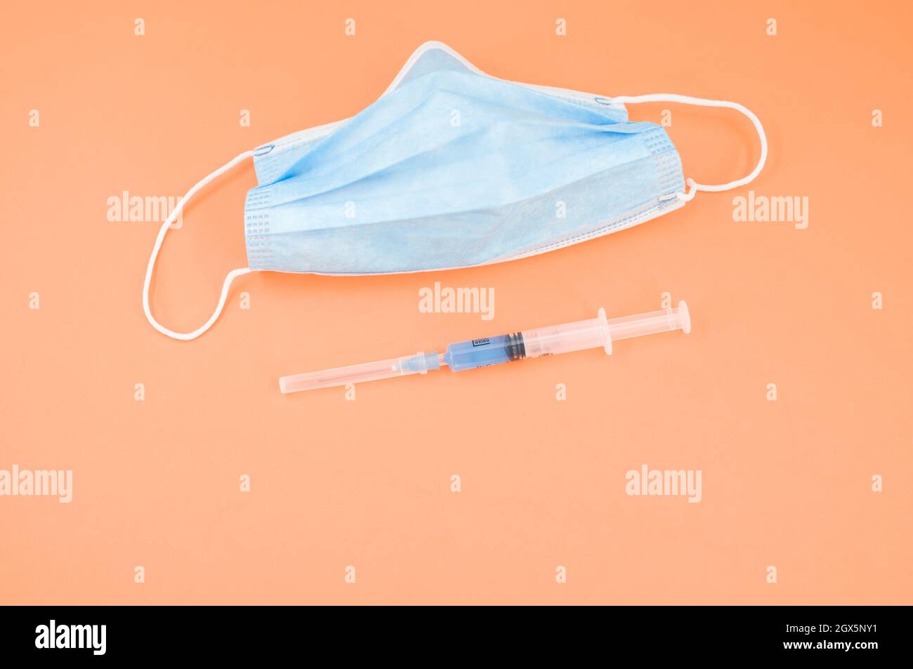 Isolated respiratory mask and syringe on an orange background Stock ...