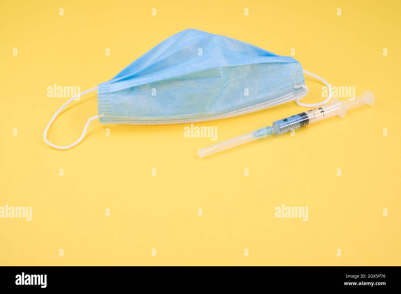 Isolated respiratory mask and syringe on a yellow background Stock ...