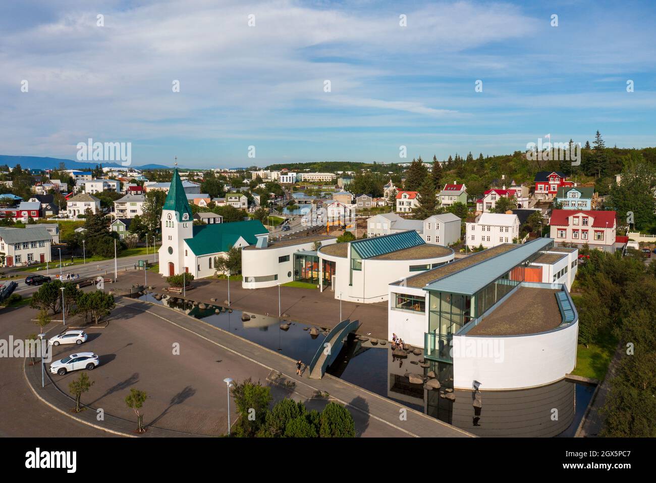 Aerial view of church building and modern cottages located against ...