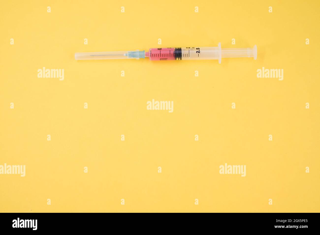 isolated sterilized injection syringe on a yellow background Stock ...