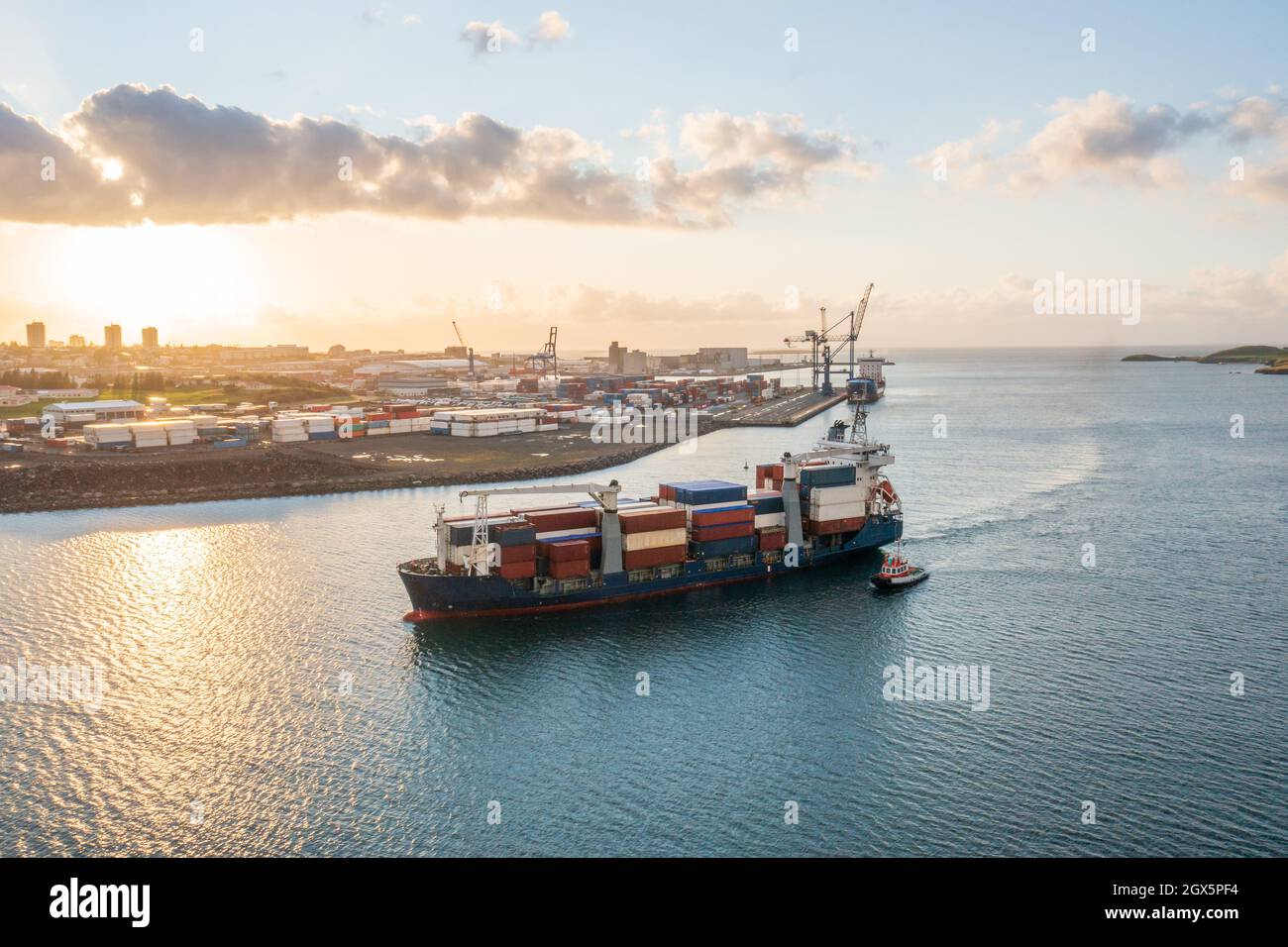 A pilot boat is guiding a cargo ship to dock Stock Photo - Alamy
