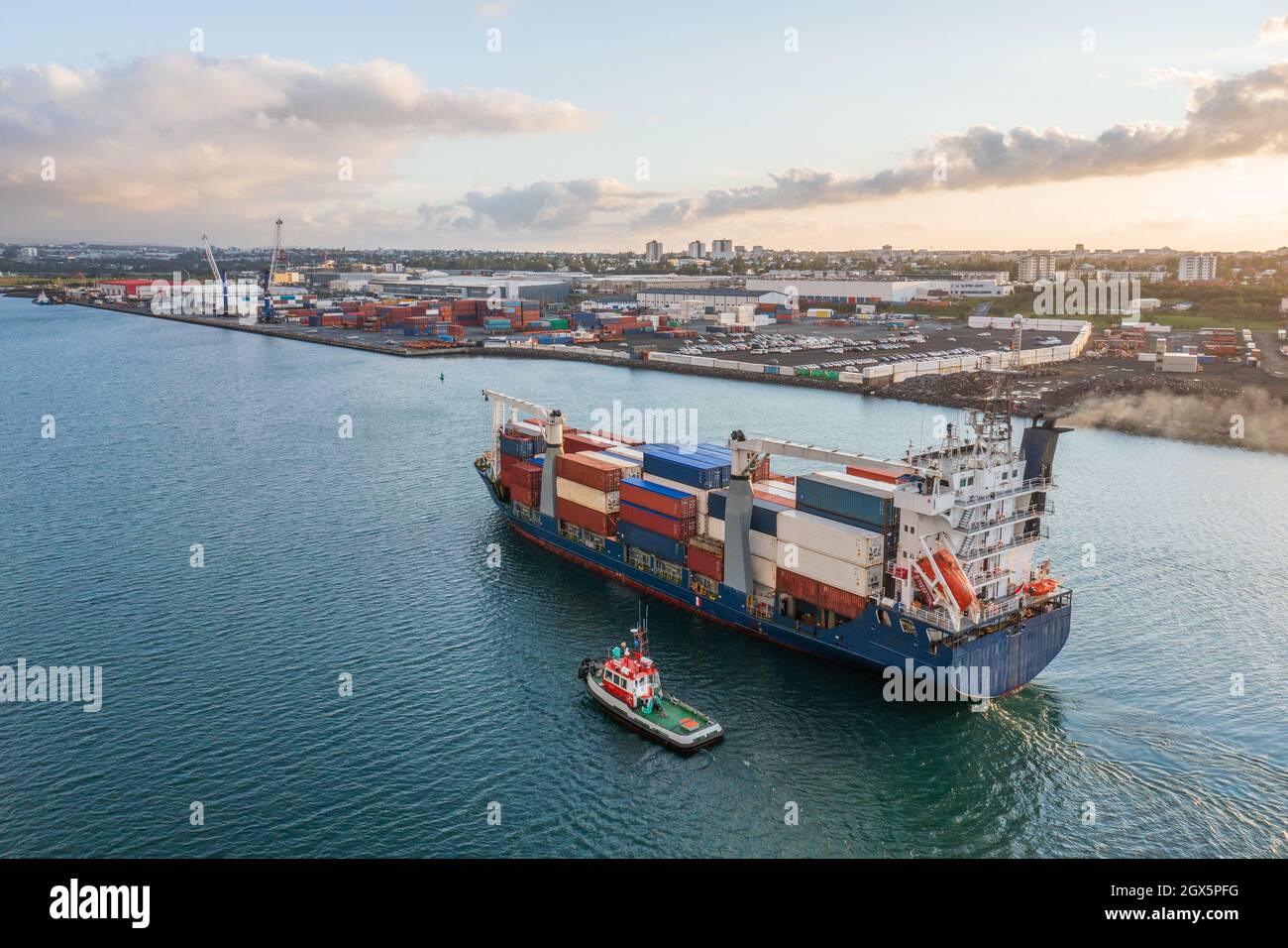 A pilot boat is guiding a cargo ship to dock Stock Photo - Alamy