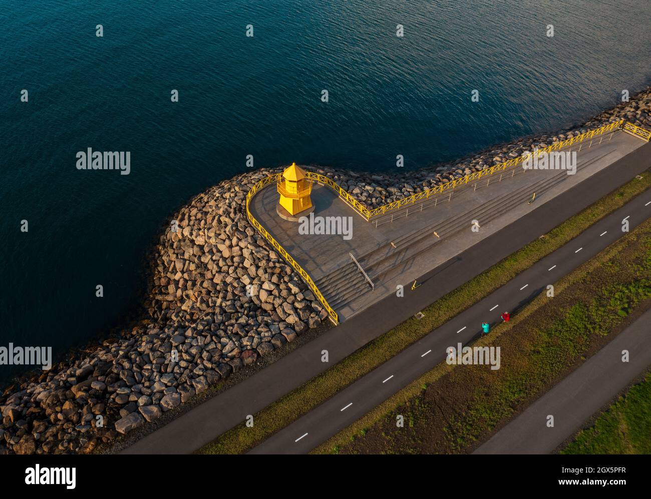 Lighthouse at a barrier in the afternoon sun Stock Photo - Alamy