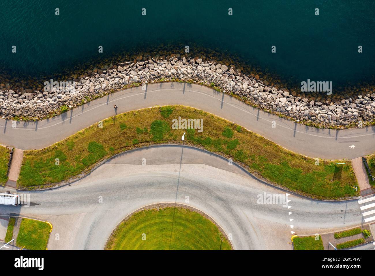 From above embankment with asphalt path and grassy lawn located between ...