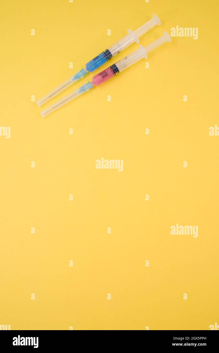 isolated sterilized injection syringe on a yellow background Stock ...