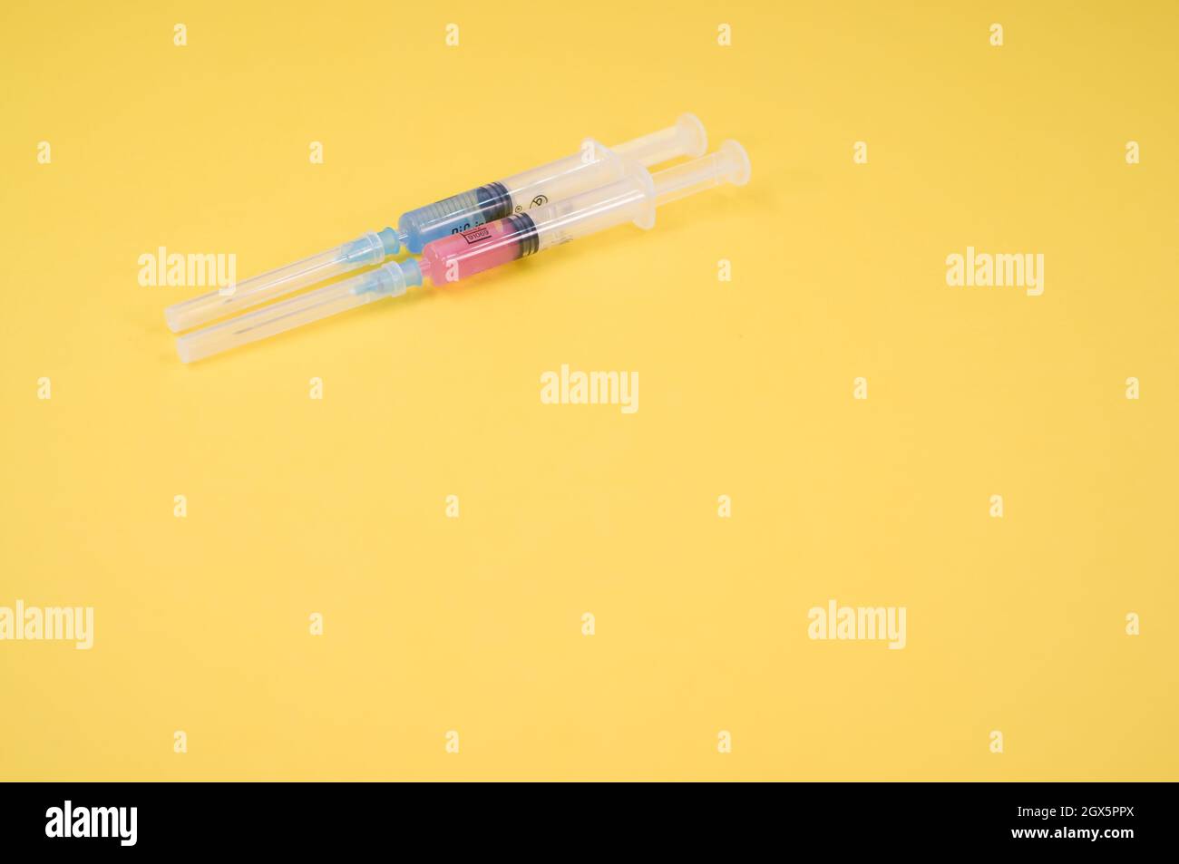 isolated sterilized injection syringe on a yellow background Stock ...