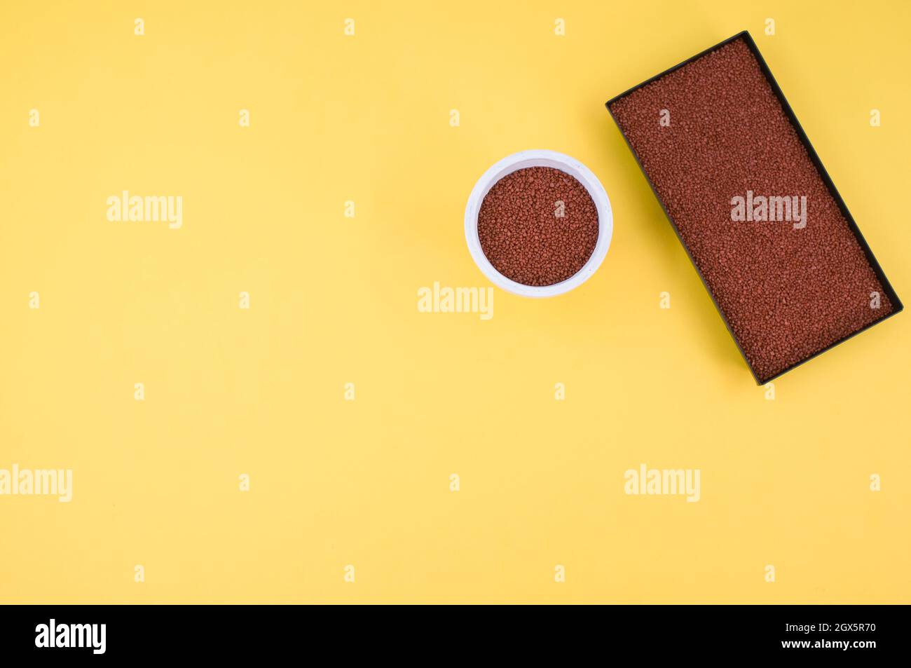 decorative orange colored sand in a metal box and white vase Stock ...