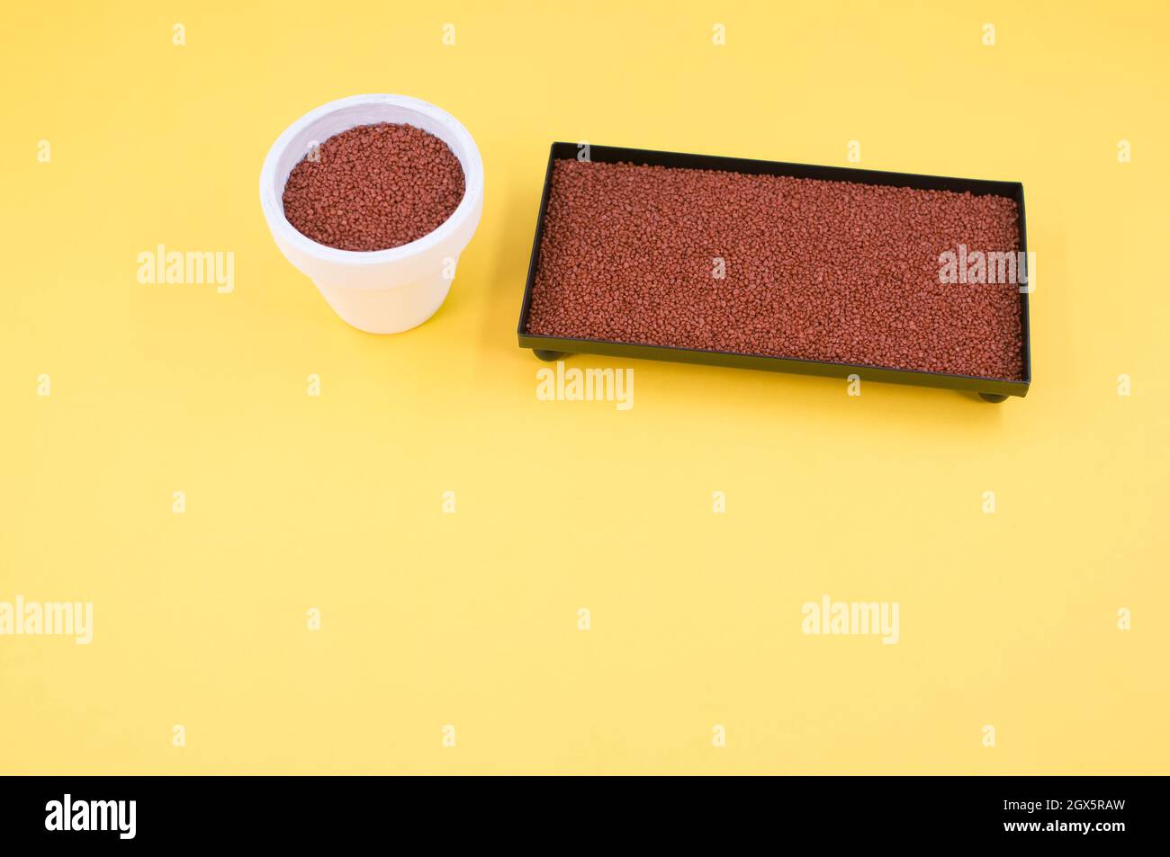 decorative orange colored sand in a metal box and white vase Stock ...