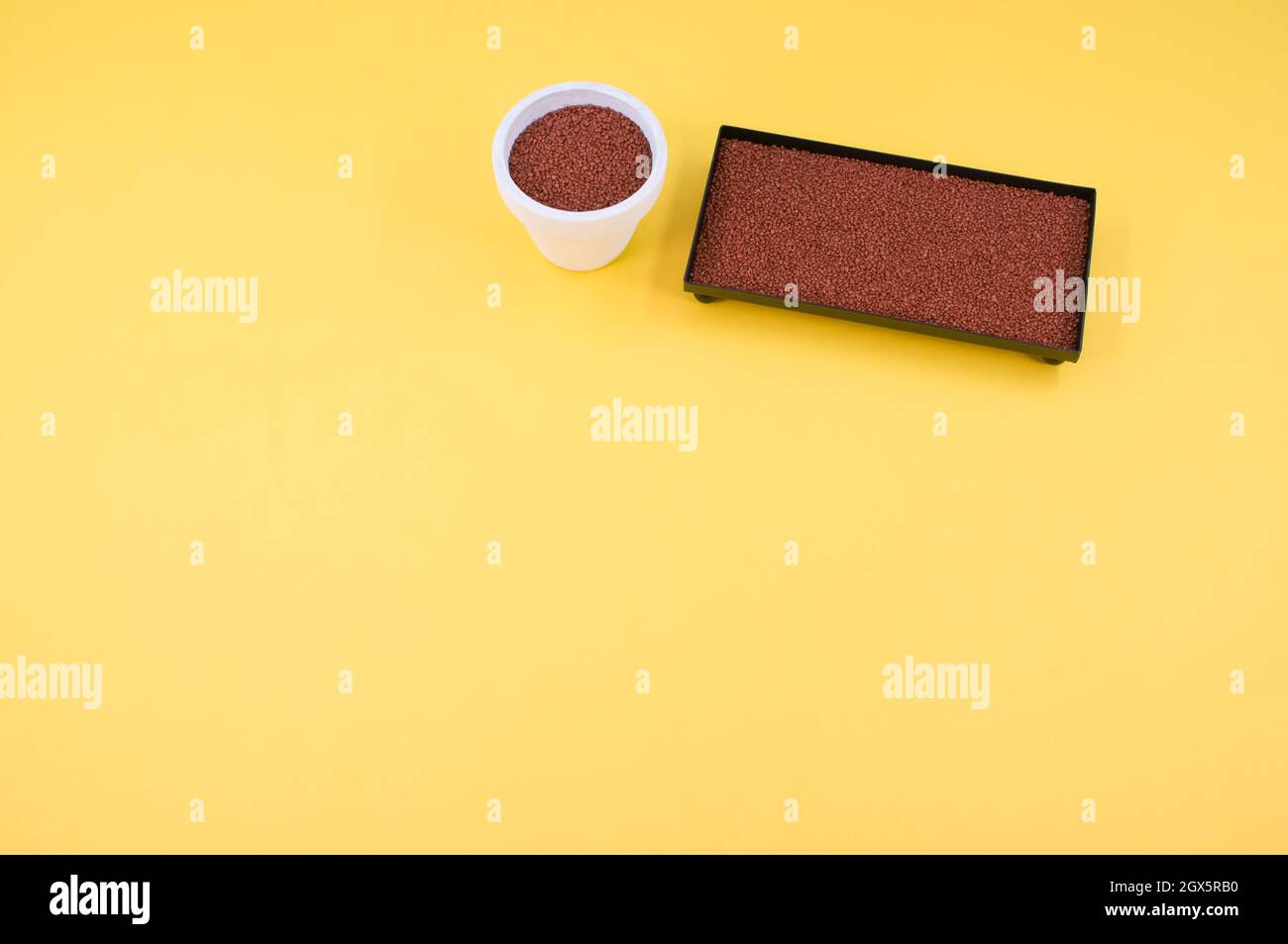 decorative orange colored sand in a metal box and white vase Stock ...