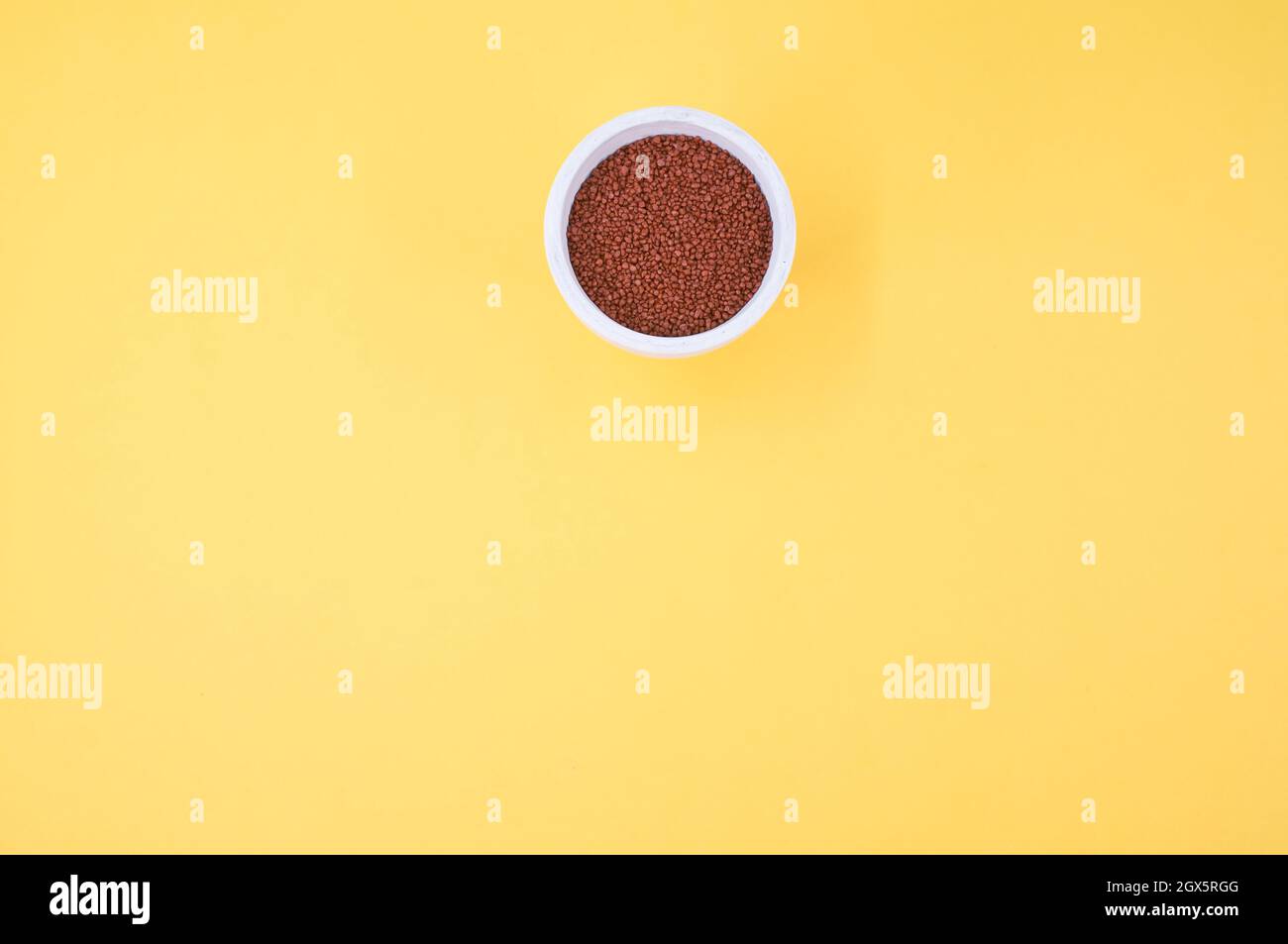 decorative orange colored sand in a white vase Stock Photo - Alamy