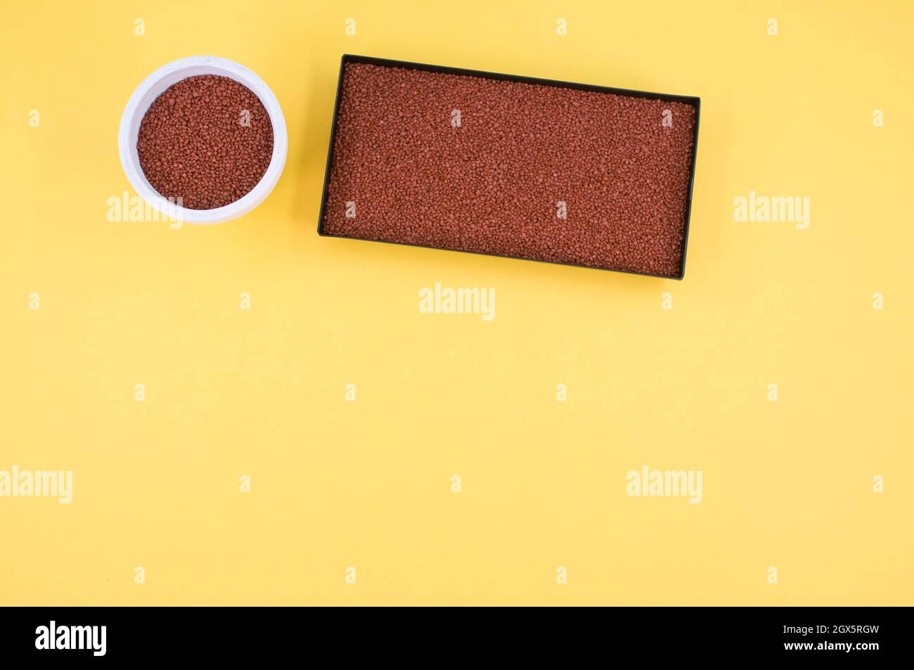 decorative orange colored sand in a metal box and white vase Stock ...