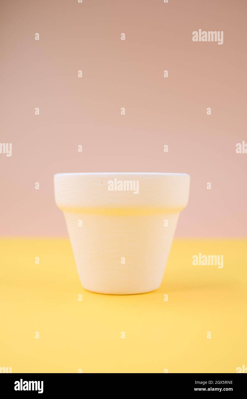 decorative orange colored sand in a white vase Stock Photo - Alamy