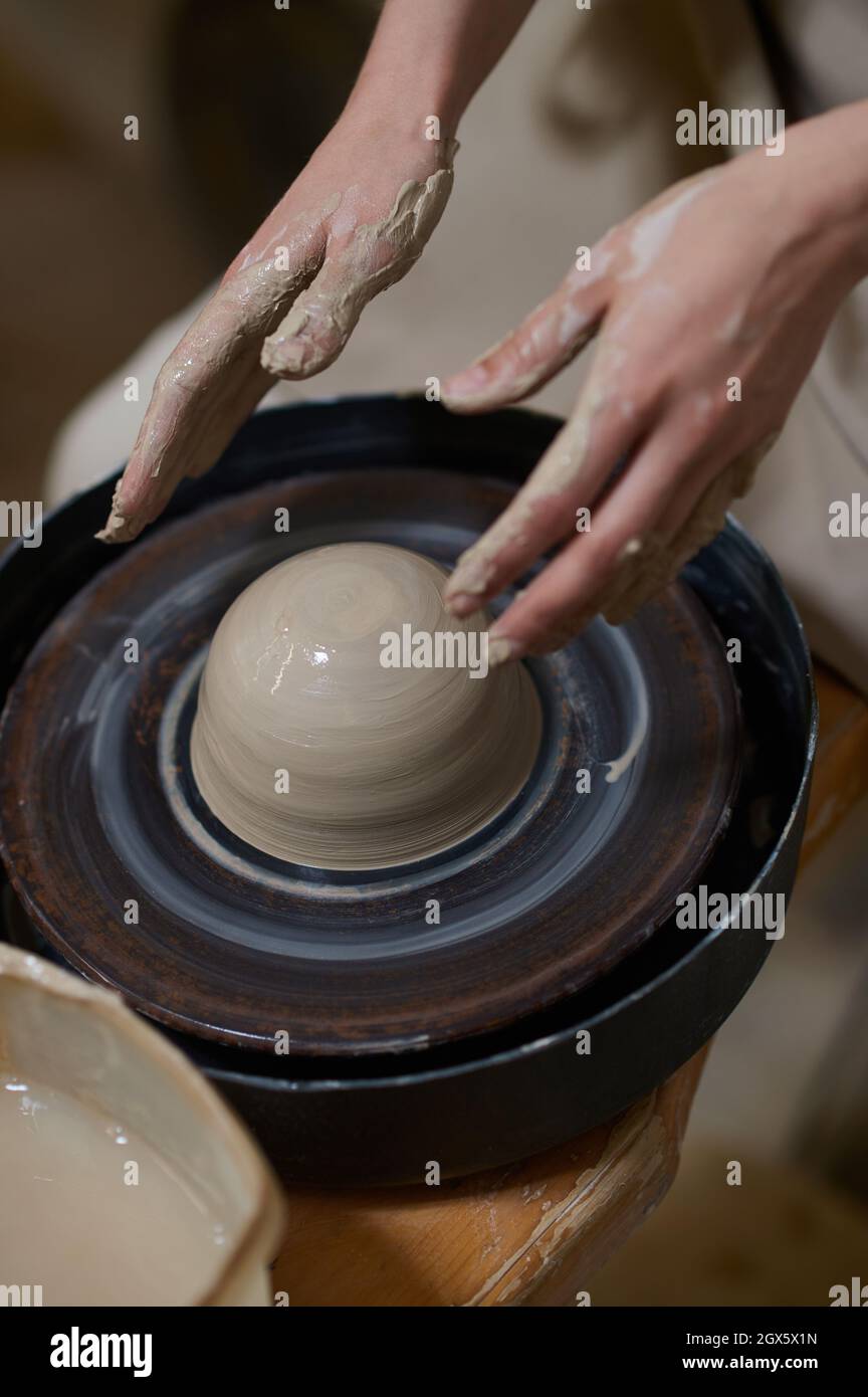 Close up of human hands molding clay on a pottery wheel Stock Photo - Alamy