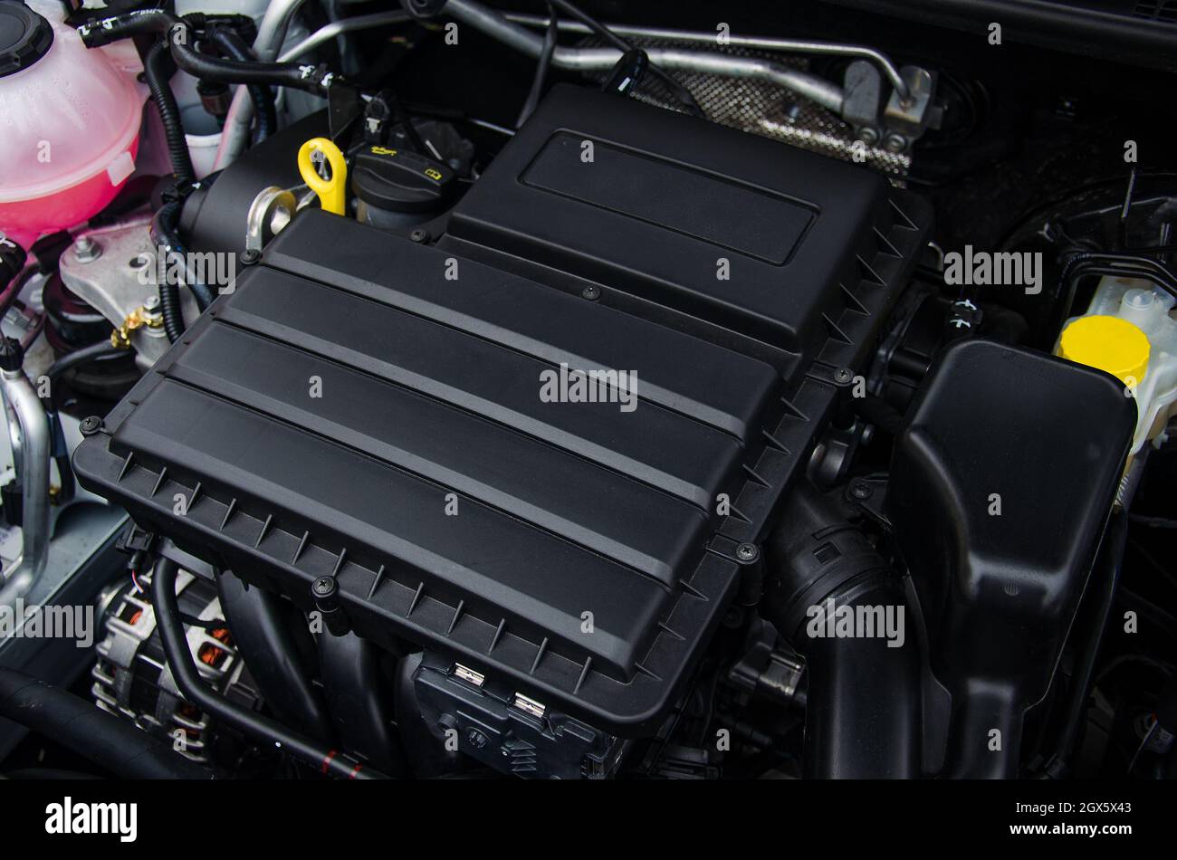 Photo of a new car engine covered with a plastic casing Stock Photo - Alamy