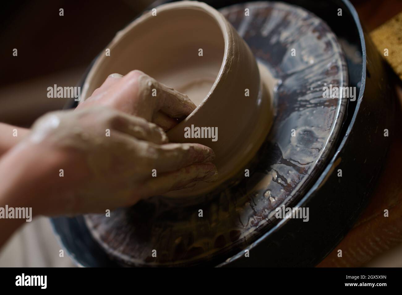 Close up of human hands making a bowl on a pottery wheel Stock Photo ...