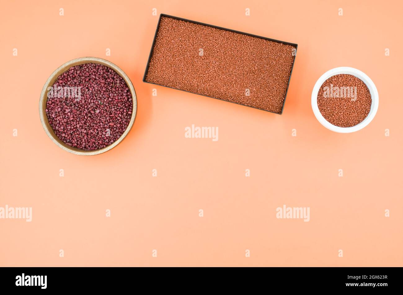 decorative orange colored sand in vases on orange background Stock ...