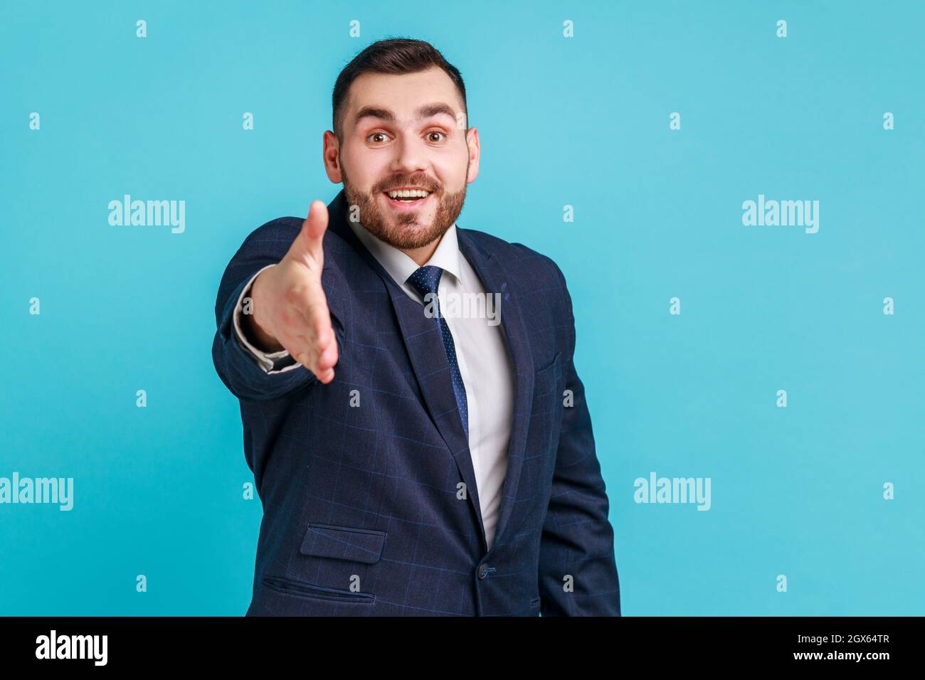 Portrait of friendly positive handsome man with beard wearing dark ...