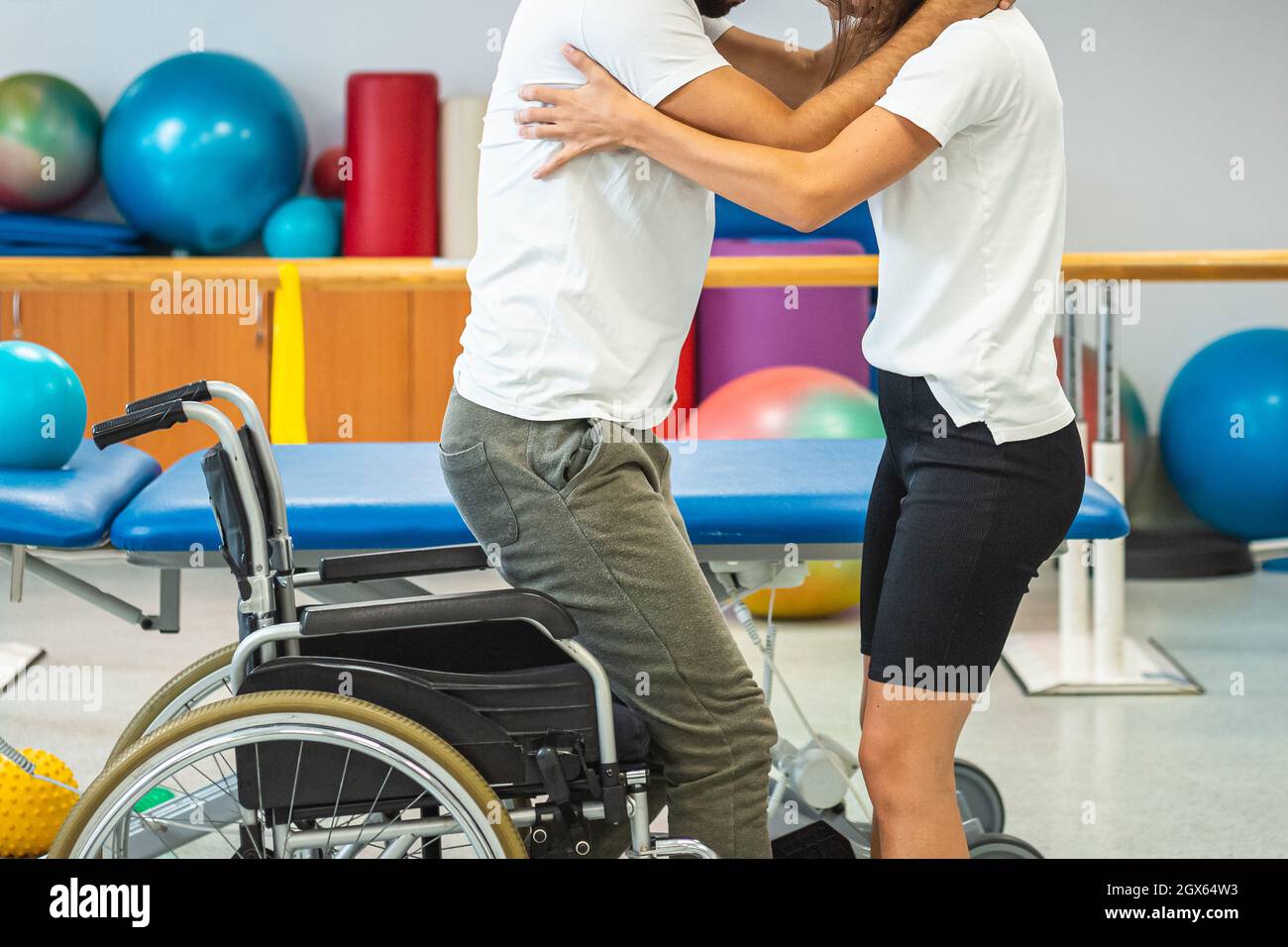 Disabled patient, and female physiotherapist, doing rehabilitation ...