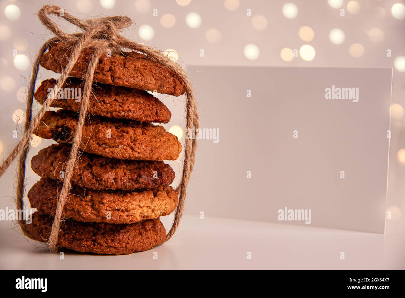 Close up of oatmeal cookies in a stack tied with brown thread and white ...