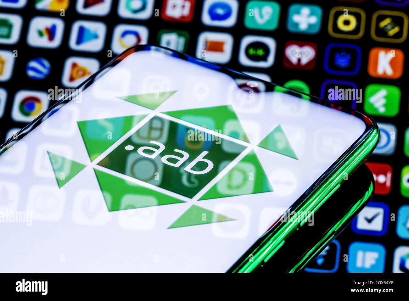 A smartphone with the AAB(Android App Bundle) logo. Many apps icons on ...