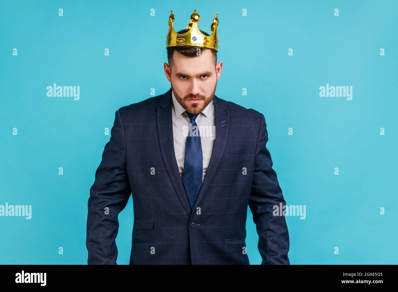 Strict bossy man in official style suit and golden crown, being on ...