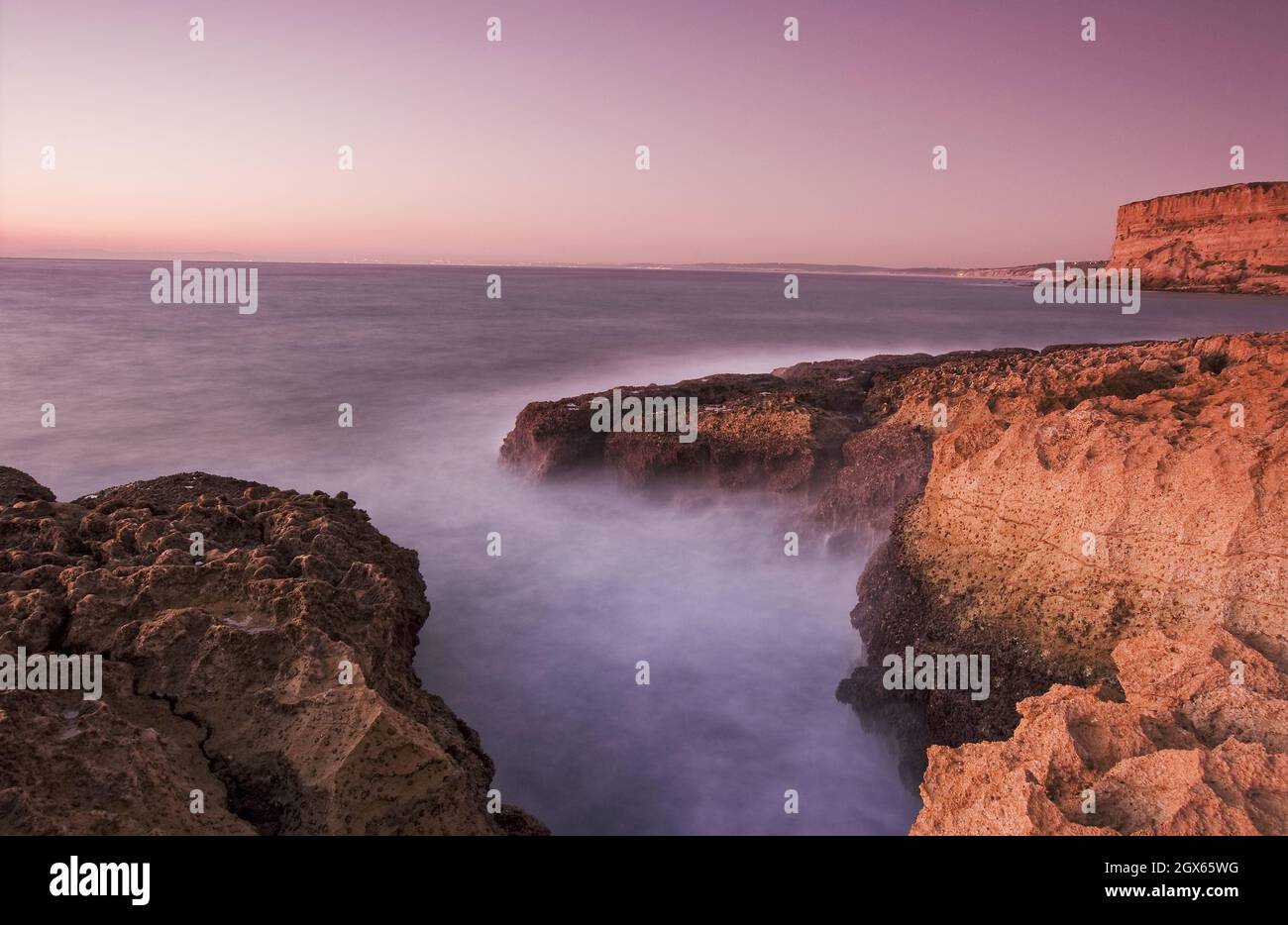 Scenic view of cliffs in Praia da Foz beach during sunset Stock Photo ...