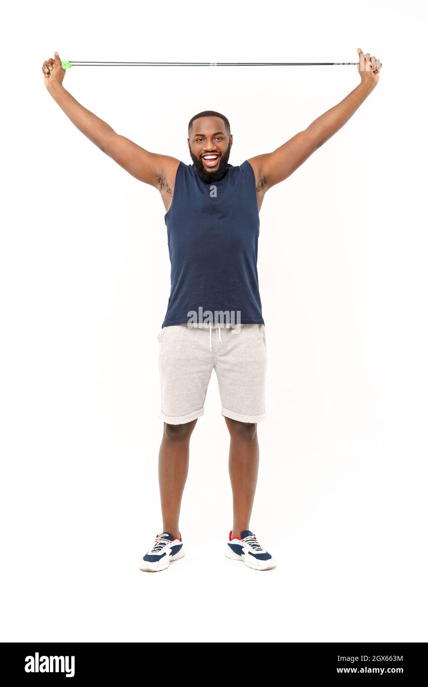 African fitness model with skipping rope against grey background ...